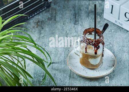 Unfinished milkshake with chocolate on mug with spoon Stock Photo - Alamy