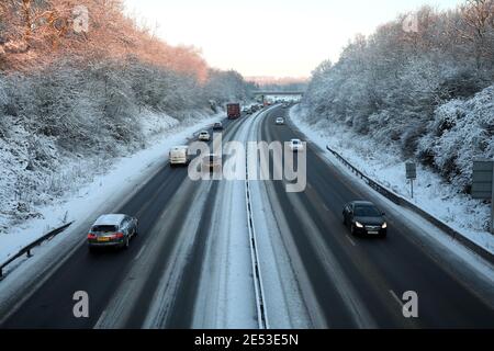 Peterborough, UK. 25th Jan, 2021. A robin sits on a snowy perch in ...