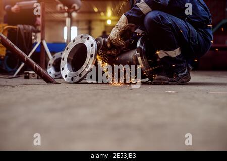 In the industrial workshop, welders wear protective equipment to weld ...