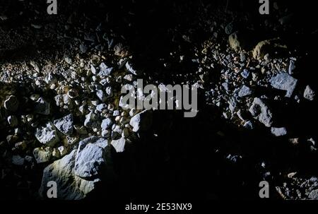 Light with bright projection on dark small stones surface Stock Photo ...