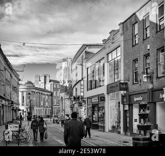 A winter afternoon in Davygate in York. Historic buildings are lit by a ...