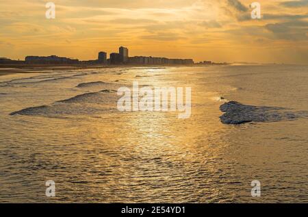 North Sea beach, Ostend, Belgium, waves crushing onto sand at sunset ...