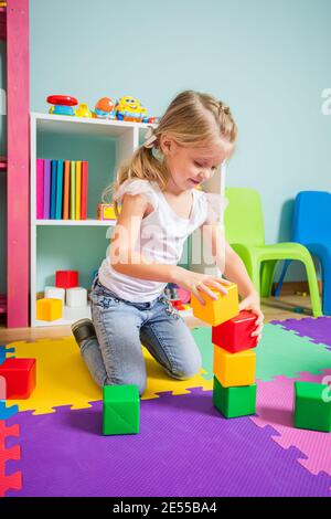 Preschool girl confidently tries to achieve her goal Stock Photo - Alamy