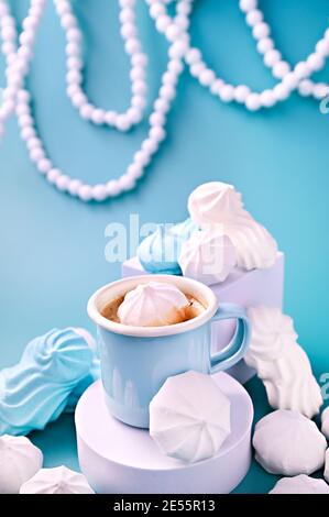 French blue meringue cookies and cup of coffee on white wooden ...