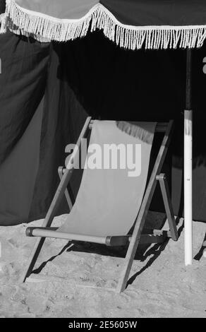 A sun umbrella at the famous sandy black beach of Perissa Santorini ...