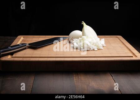 Diced onion on a wooden cutting board. Sliced white onion Stock Photo ...