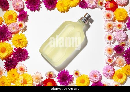 Bottle of fragrance surrounded by flower buds Stock Photo - Alamy