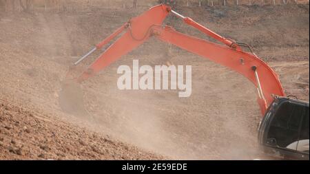Orange excavator Under construction Large reservoir, Dust by digging ...