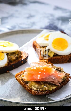 Toasted breads with boiled egg and avocado. Guacamole sandwiches ...
