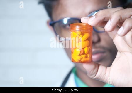 doctor hand holding pill container with copy space Stock Photo - Alamy