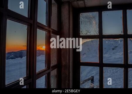 sunset seen through window with chipped glass Stock Photo - Alamy
