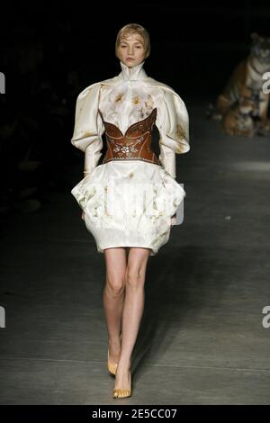 A model presents a creation by designer Alexander Mc Queen as part of ...