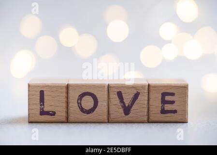 Word LOVE made from wooden letter blocks and a miniature house model ...