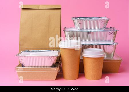 Diverse of paper containers for takeaway food. Delivery man is carrying ...