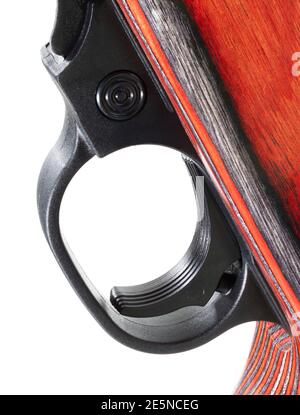 Safety button and trigger on a rifle with red and black wood laminated ...