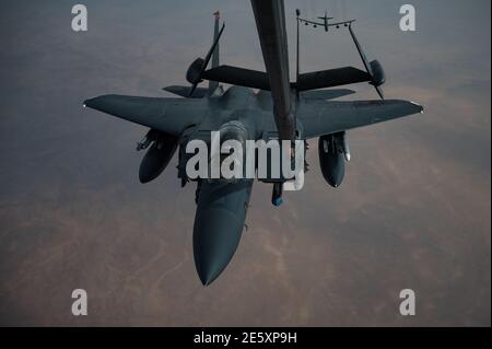 An aerial view of Two F15 fighter jets flying together overhead against ...