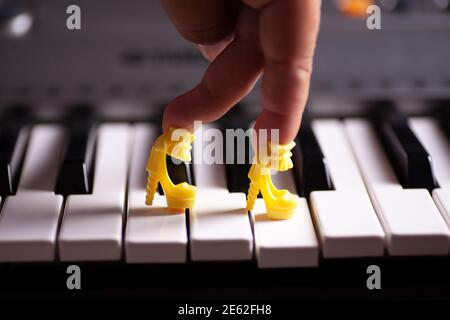 Toy piano yellow on white background Stock Photo - Alamy
