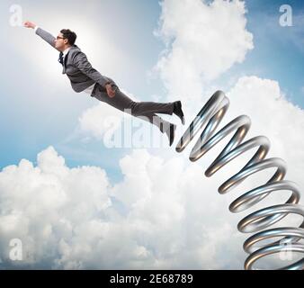 Businessman jumping from spring in business concept Stock Photo - Alamy