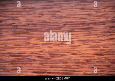 Mahogany polished flat surface of natural red wood with a striped cut ...