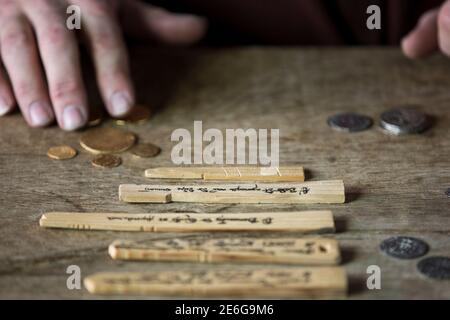 Medieval merchant counting money using tally sticks Stock Photo - Alamy