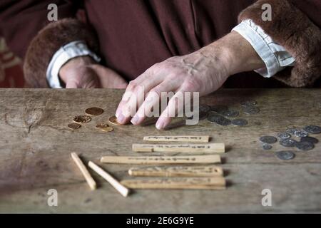 Medieval merchant counting money using tally sticks Stock Photo - Alamy