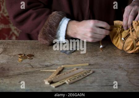 Medieval merchant counting money using tally sticks Stock Photo - Alamy