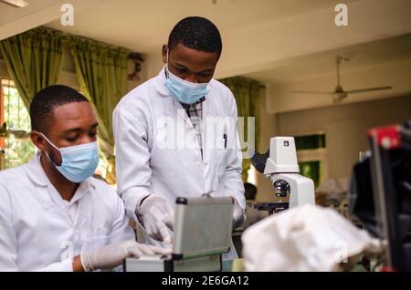 Young black scientists carrying out some experiments in the laboratory ...