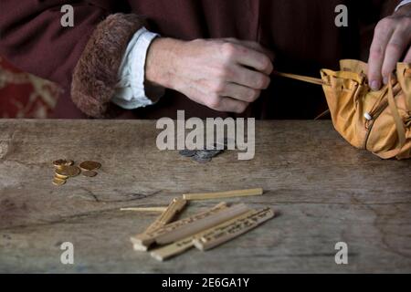 Medieval merchant counting money using tally sticks Stock Photo - Alamy