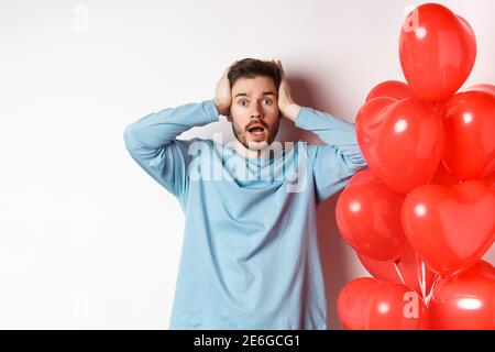 Valentines day and love concept. Confused and shocked girl staring ...