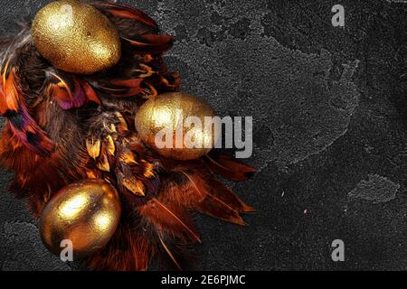Easter eggs and feathers on dark background. Flat lay, Top view. Easter ...