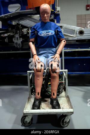 A crash test dummy sits in the driver's seat of a car after a crash ...
