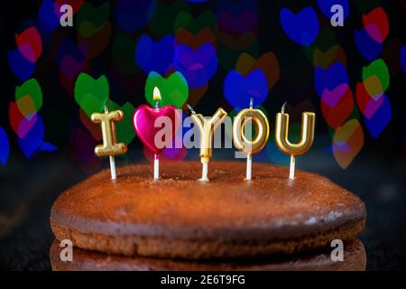 Basic cake with I love you candles, heart, placed on a vintage table ...