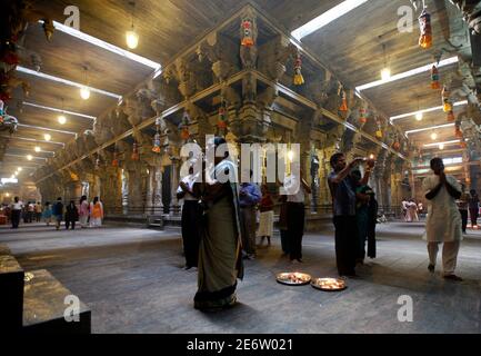 Hindu worshippers make offerings to their gods & goddesses at a Ganga ...