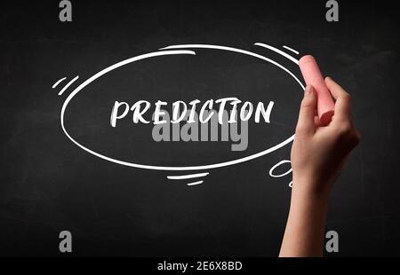 Hand drawing PREDICTION inscription with white chalk on blackboard ...