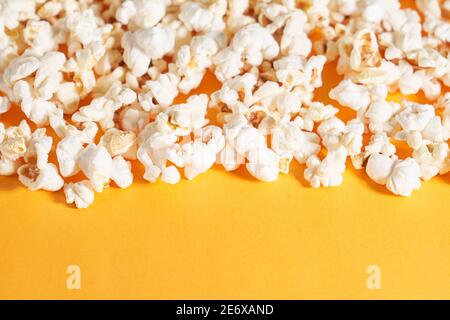Close up of neatly folded popcorn on orange background. Concept of ...