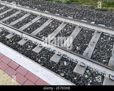 Train tracks with tiny pebbles at daytime Stock Photo - Alamy