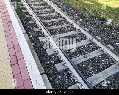 Train tracks with tiny pebbles at daytime Stock Photo - Alamy