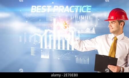 Handsome businessman with helmet drawing BEST PRACTICE inscription ...