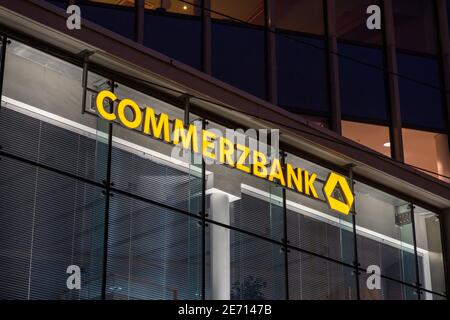 Commerzbank logo on a building illuminated in yellow color. Bank branch ...