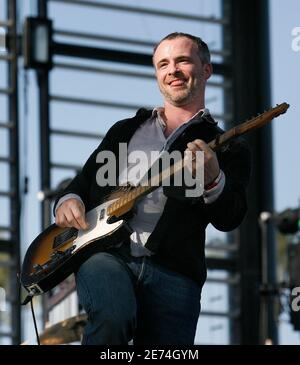 Fran Healy (L) lead singer of Travis talks to bass guitarist Dougie ...