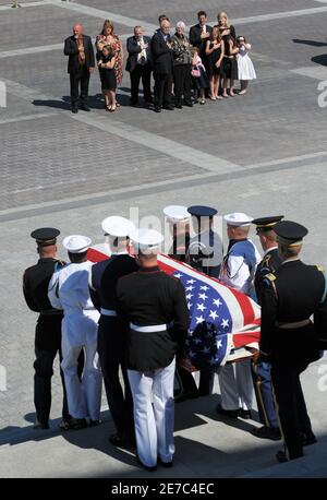 Family members watch as pall bearers carry the casket of Sergeant Kirk ...