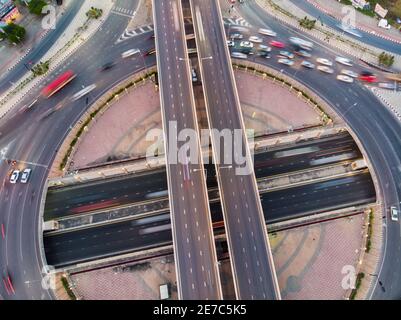 Circular junction cross transport road with car movement aerial view ...