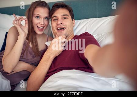 Young Couple Pose For Selfies In Front Of The Banner For The Wnbr World