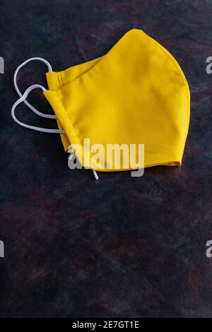 Eco-friendly reusable fabric safety mask on a pink background banner ...