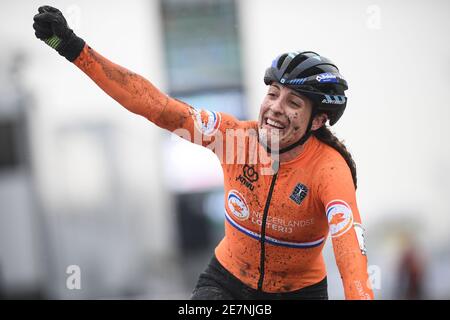 Dutch Lucinda Brand celebrates as she crosses the finish line carrying ...