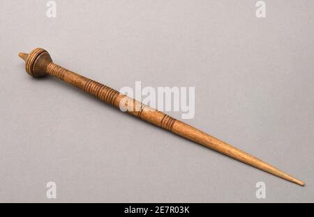 Vintage wooden spindle on gray background Stock Photo - Alamy