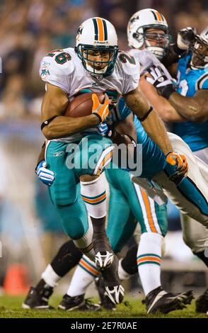 Miami Dolphins' Lex Hilliard (26) goes over the top of the line to ...