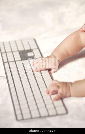 Baby touching computer keyboard high quality photo Stock Photo - Alamy