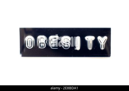 Embossed letter with word overweight in black banner on white paper ...