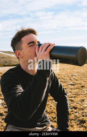 Thermos and backpack of tourist on meadow in forest Stock Photo - Alamy